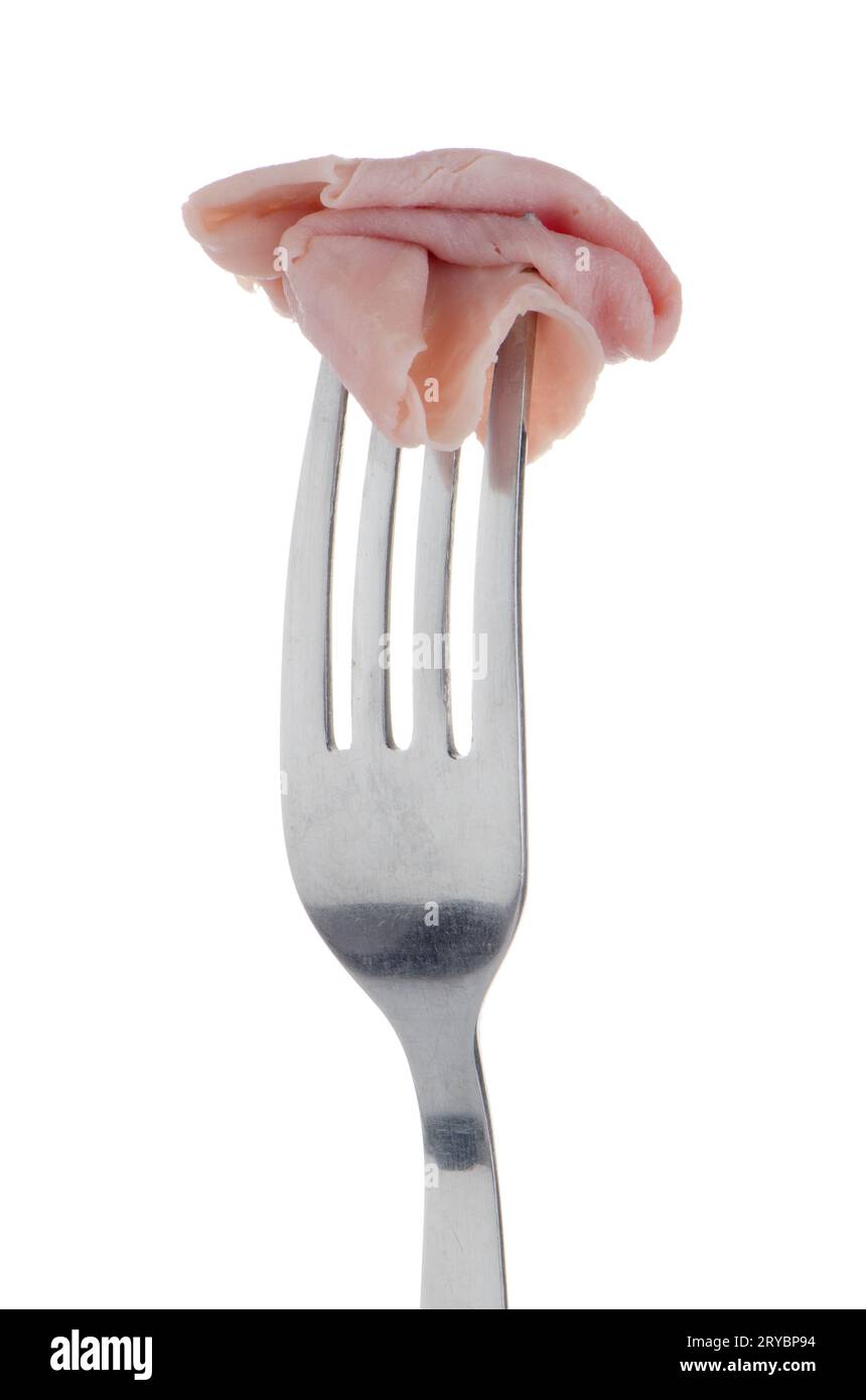 Slice of ham skewered on a fork Stock Photo - Alamy