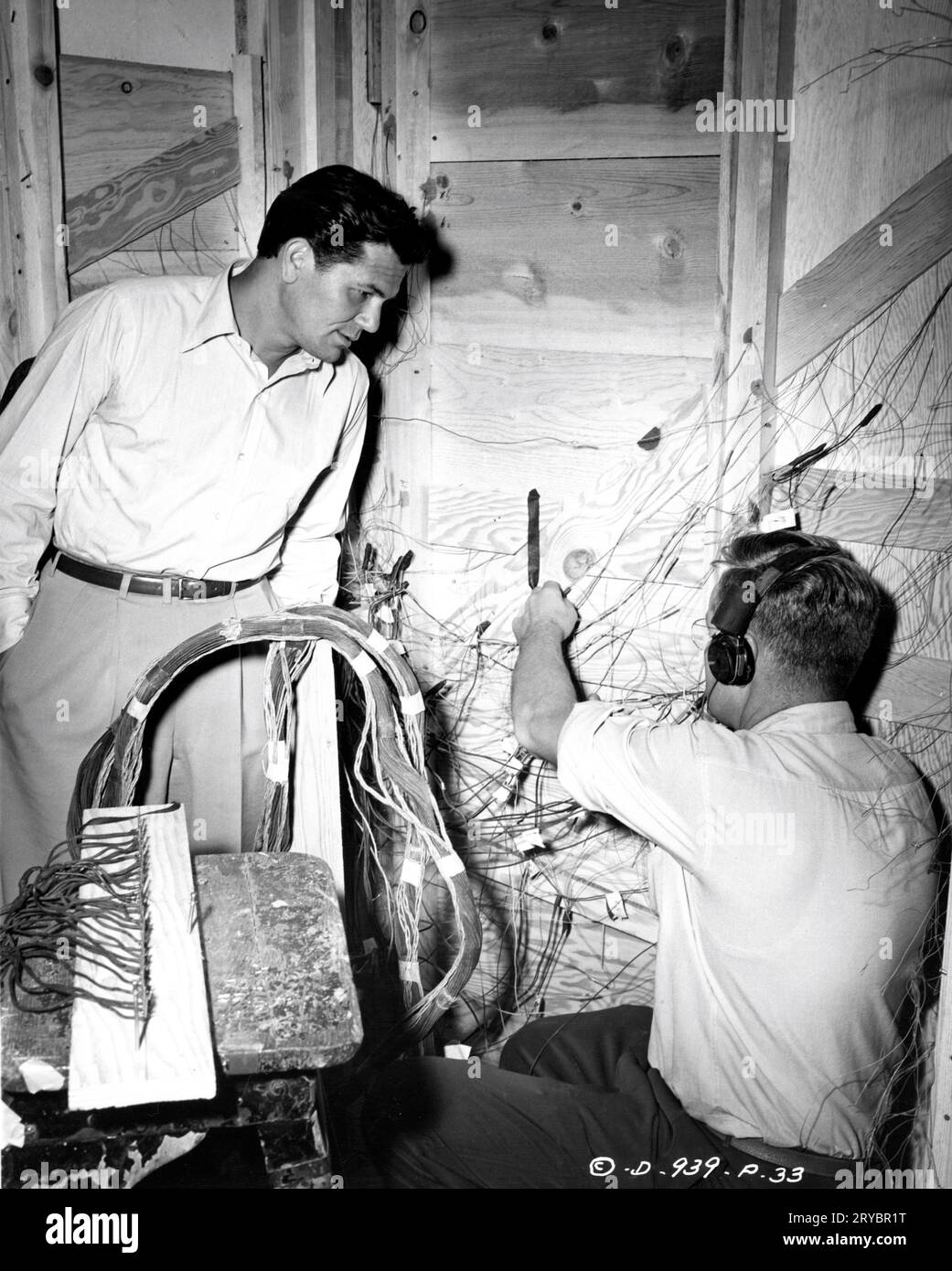 JOHN GARFIELD on set candid watching Special Effects Expert wiring up ...