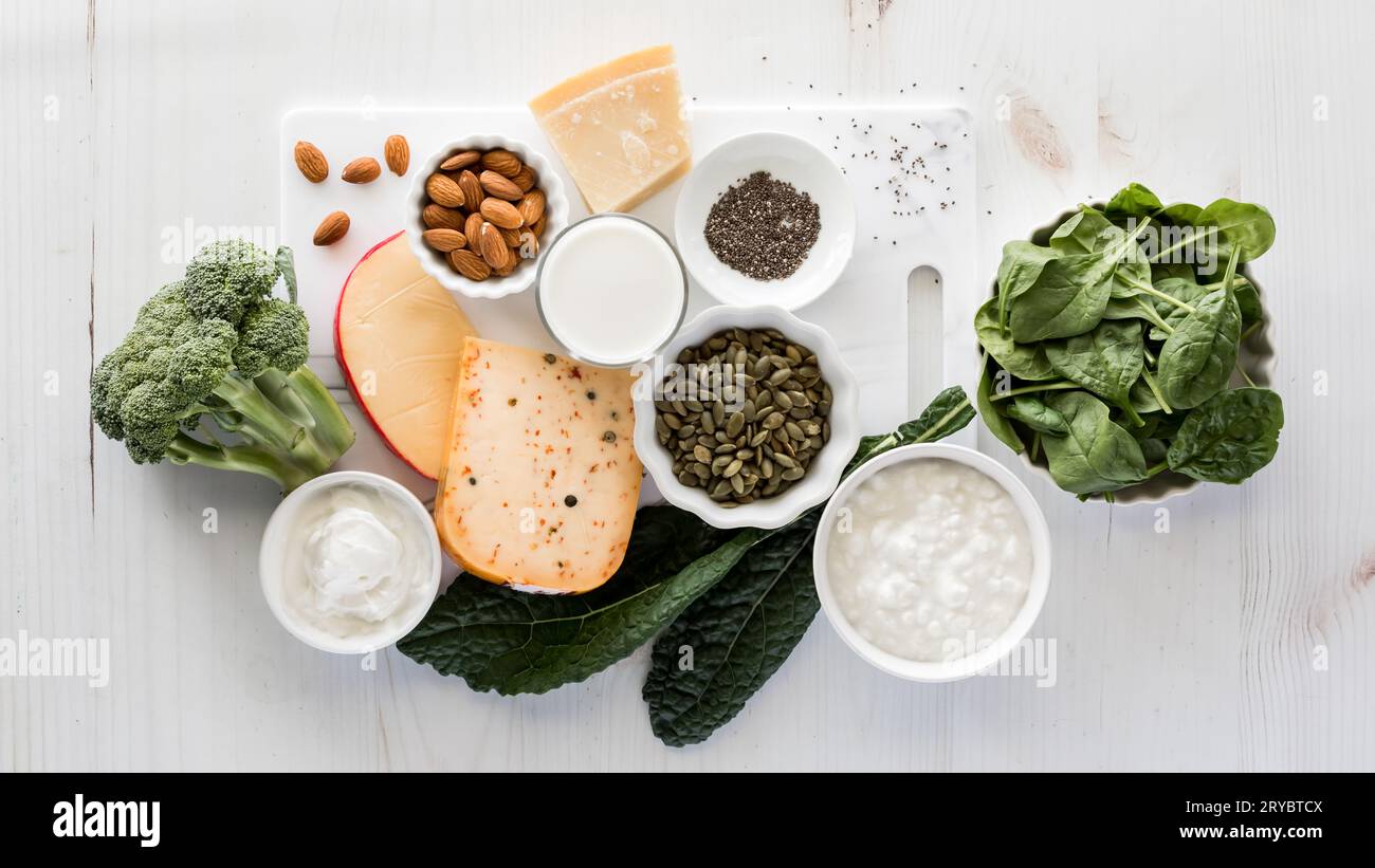 A variety of calcium rich foods including nuts, seeds, dairy and greens ...