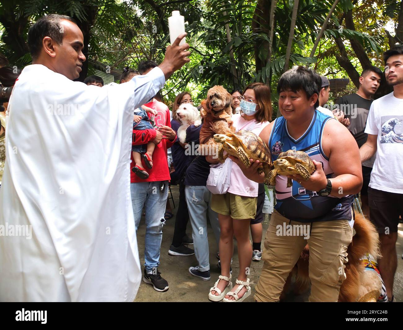 A priest bless the two turtles with holy water during the pet blessing ...