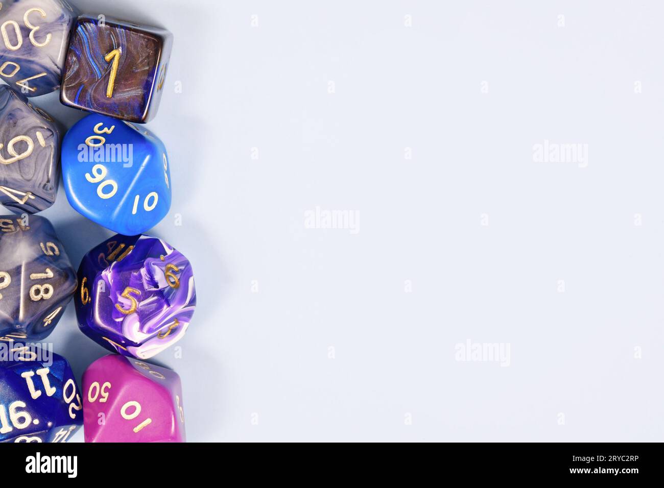 Blue and purple roleplaying game RPG dice on side of light gray ...