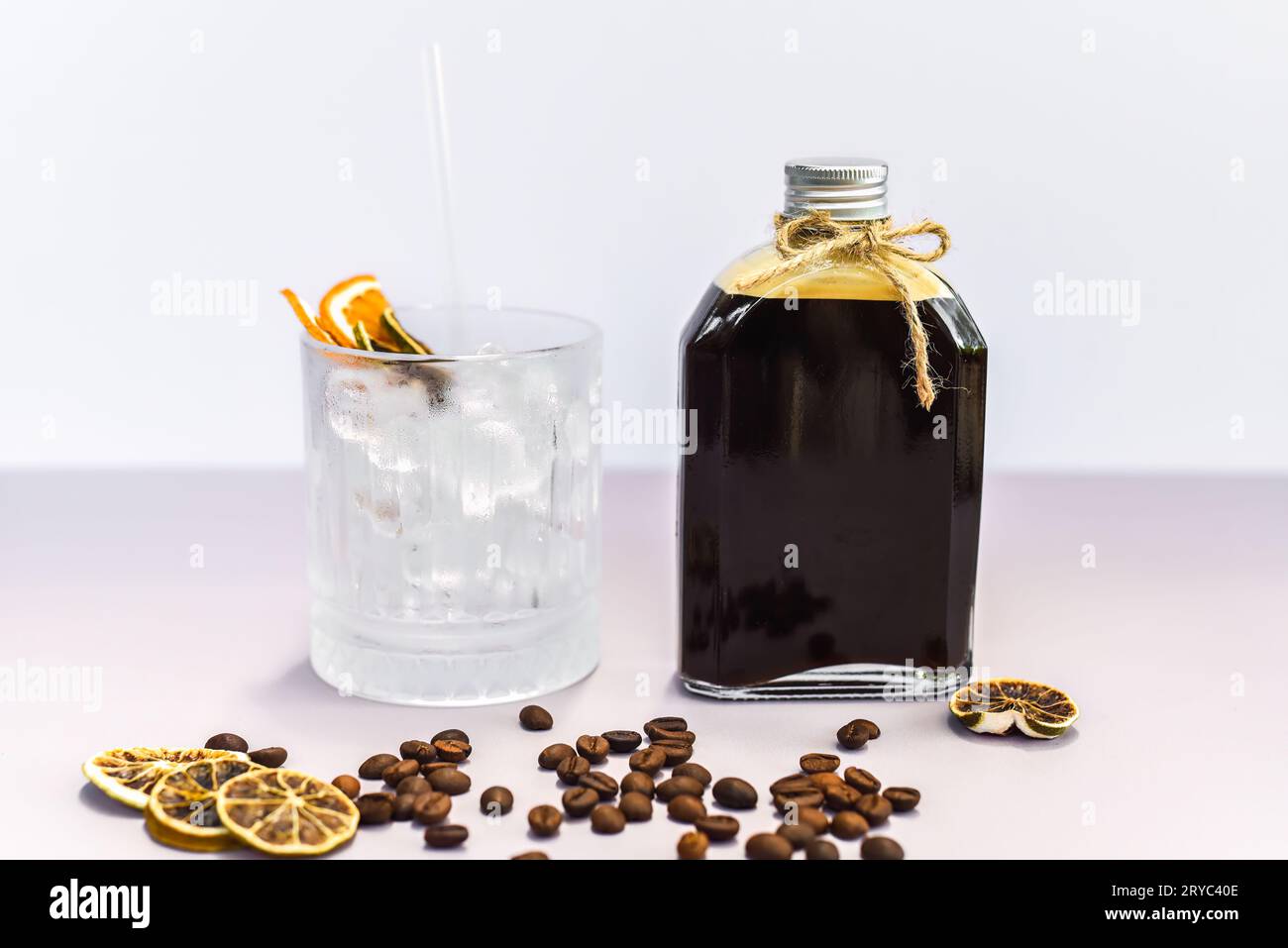 Cold brew coffee in a bottle with transparent glass full of ice on ...
