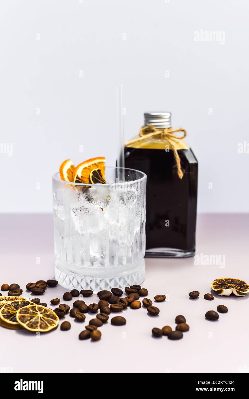 Cold brew coffee in a bottle with transparent glass full of ice on ...