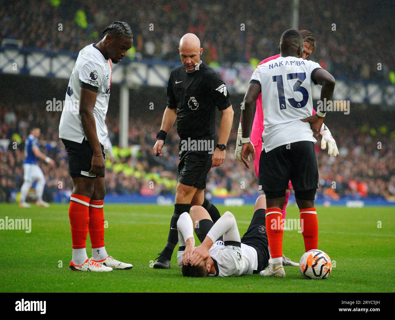Luton Town's Mads Juel Andersen reacts after colliding with Everton's ...