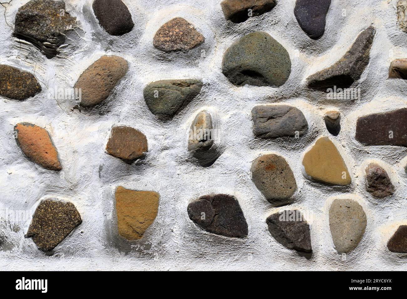 Pebble wall, path, sidewalk. Gray, yellow pebbles, cement mortar ...