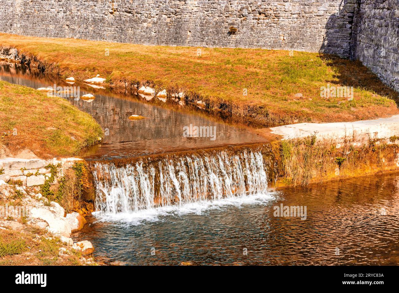 Waters bathing hill village Stock Photo - Alamy