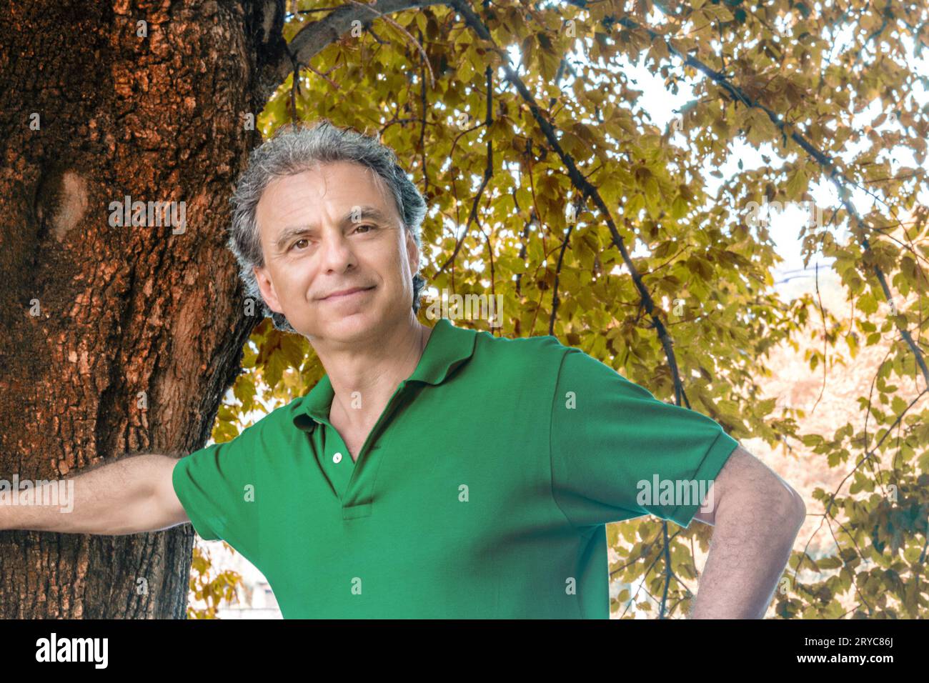 Cute man under a tree Stock Photo - Alamy
