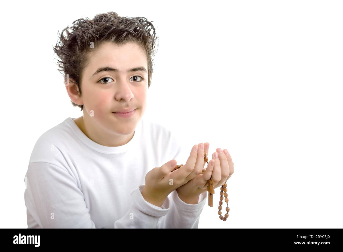 A boy is praying holding Rosary with both hands Stock Photo - Alamy