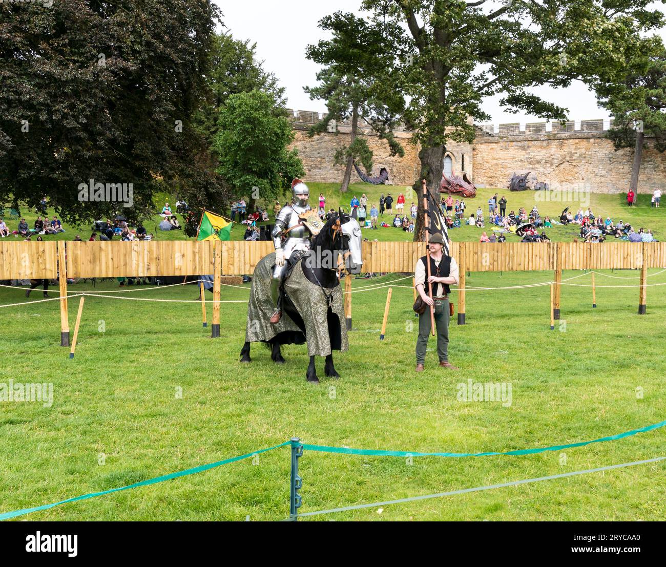 Knight on horseback with squire holding banner hi-res stock photography ...
