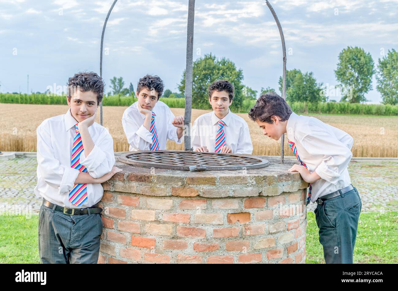 Boys over well Stock Photo - Alamy