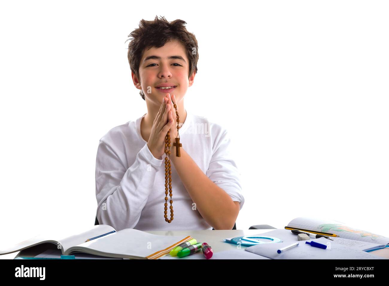 Boy prays with a rosary with clasped hands on blank book Stock Photo ...