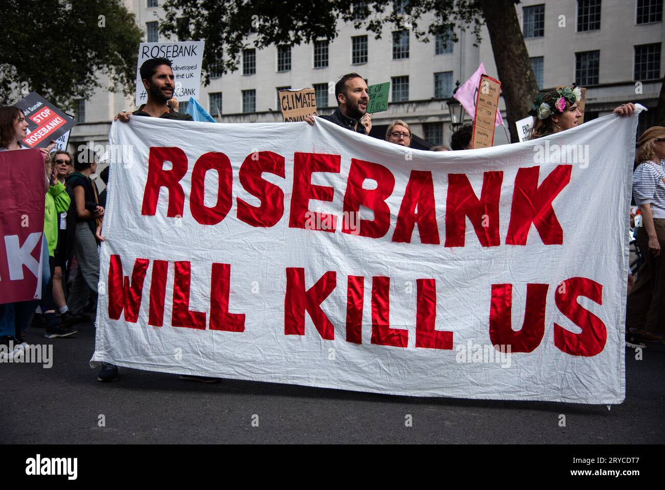 London, UK. 30th Sep, 2023. Protestors march with a large banner during ...