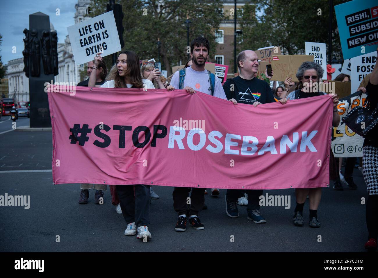 London, UK. 30th Sep, 2023. Protestors march with a large banner during ...