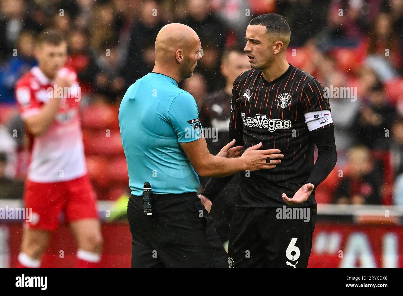 Referee Charles Breakspear speaks to Oliver Norburn #6 of Blackpool ...