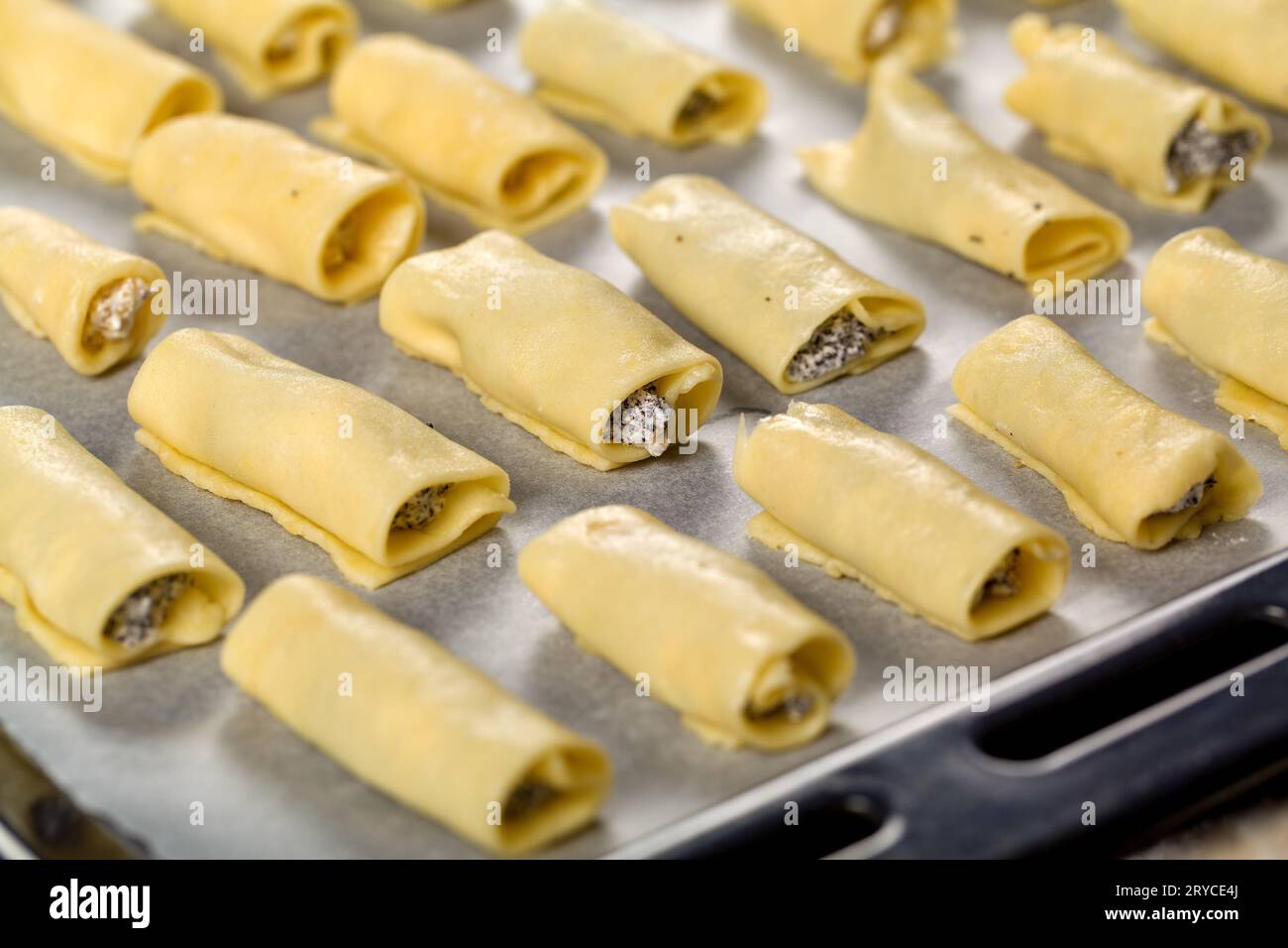Formed puff pastry rolls with poppy seed and nut filling are ready for ...