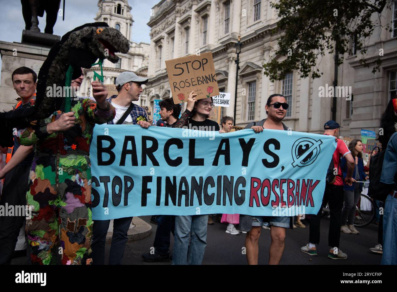 London, UK. 30th Sep, 2023. Protestors march with a large banner during ...
