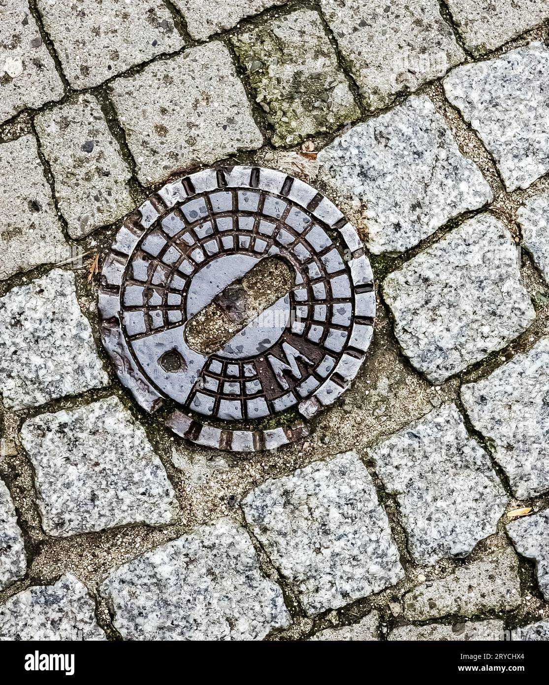 Closed sewer manhole on an old paved road.Top view Stock Photo - Alamy