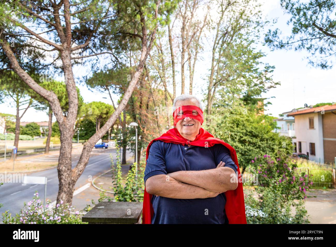Senior dressed as superhero with red cape and mask Stock Photo - Alamy