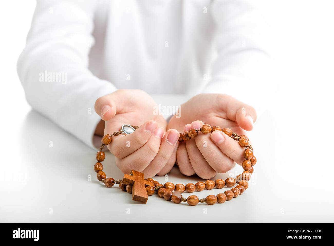 Child hands offer wooden rosary beads Stock Photo - Alamy