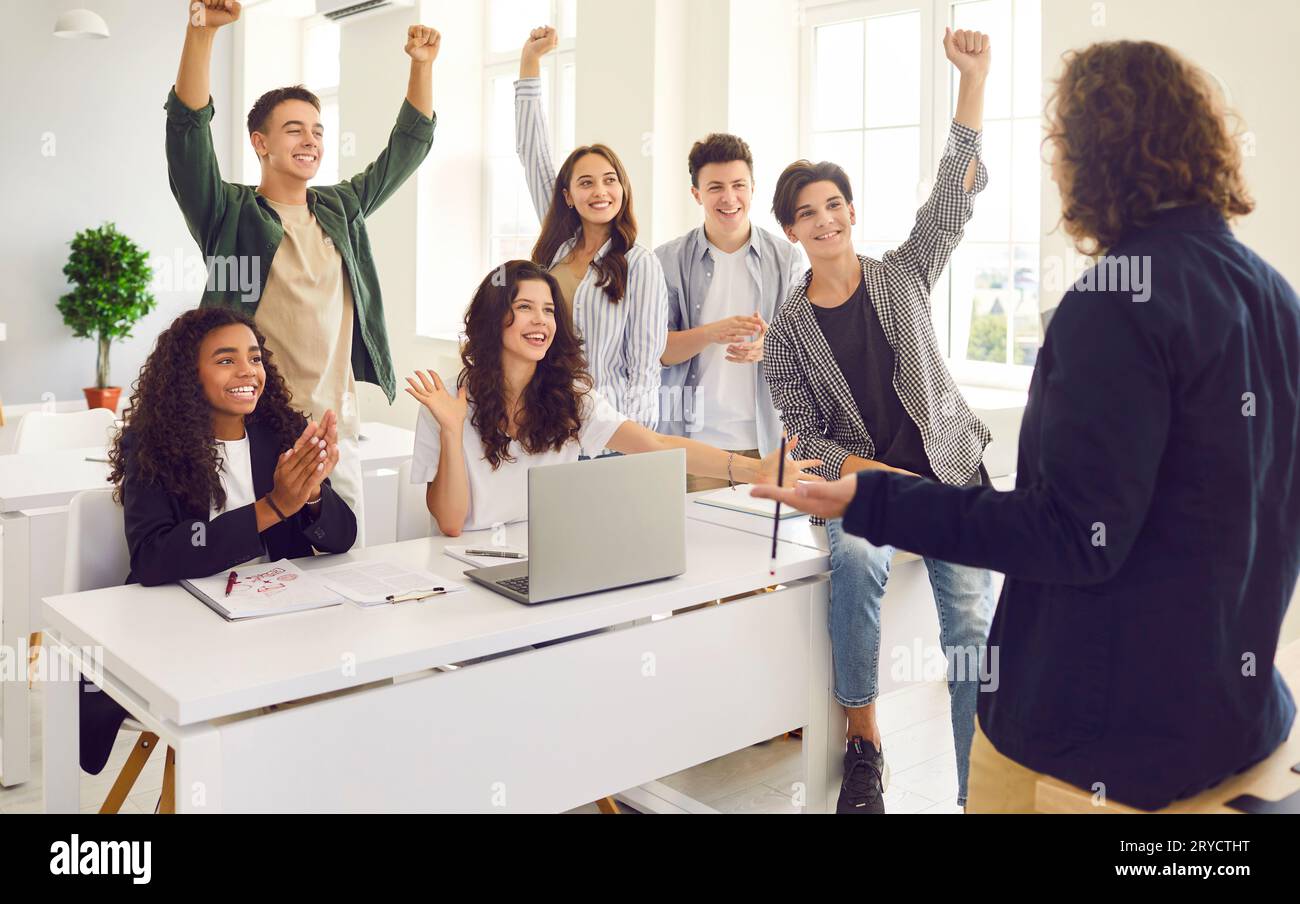 Cheerful multiracial students having fun celebrating success during ...