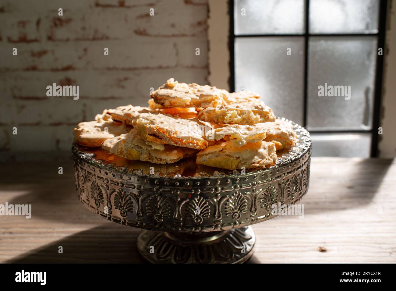 In front of a frosted window are almond rhombuses, an Advent pastry ...