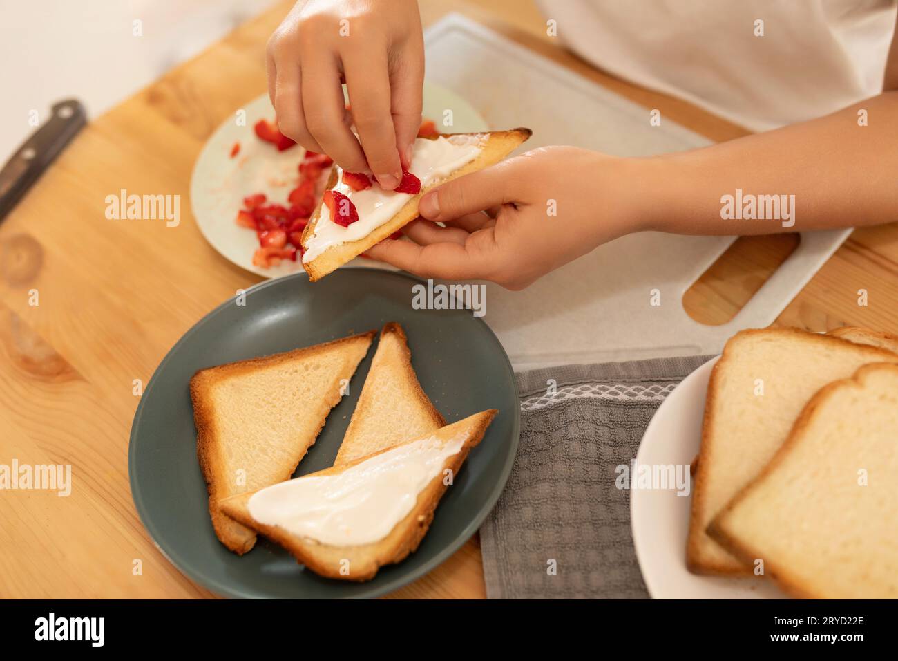 a woman makes a sandwich for a snack in the kitchen Stock Photo - Alamy