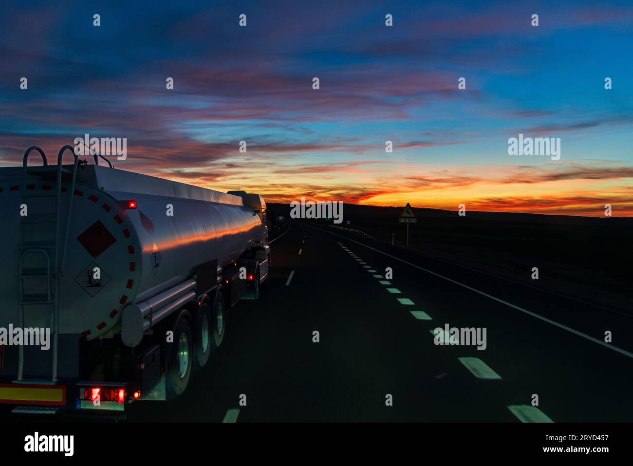 Fuel tanker truck driving on a highway at night Stock Photo - Alamy