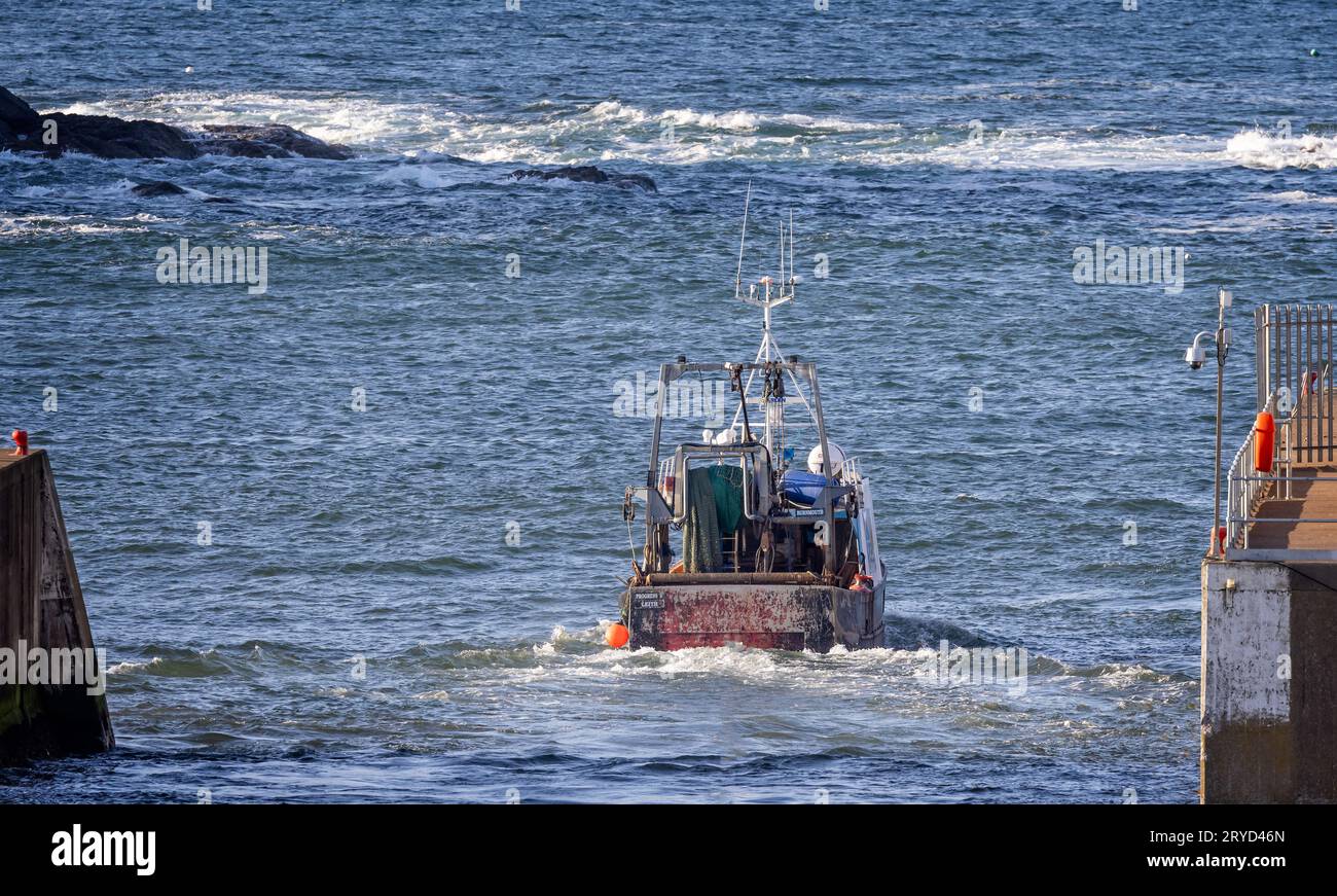 Fishing trawler leaving Eyemouth harbour in rough seas in Eyemouth ...