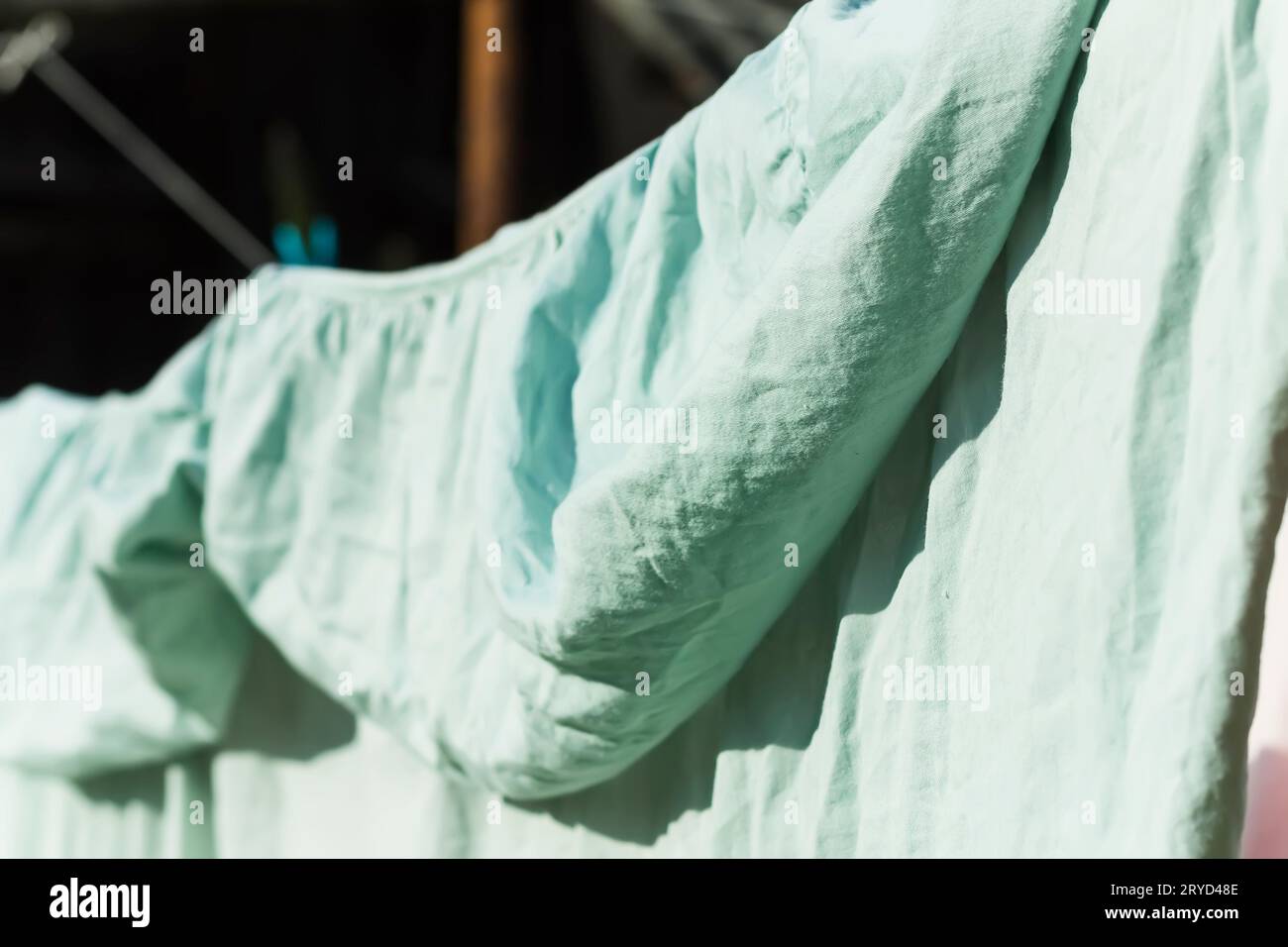 Washed colorful cotton laundry hanging on the rope. Textile drying on ...