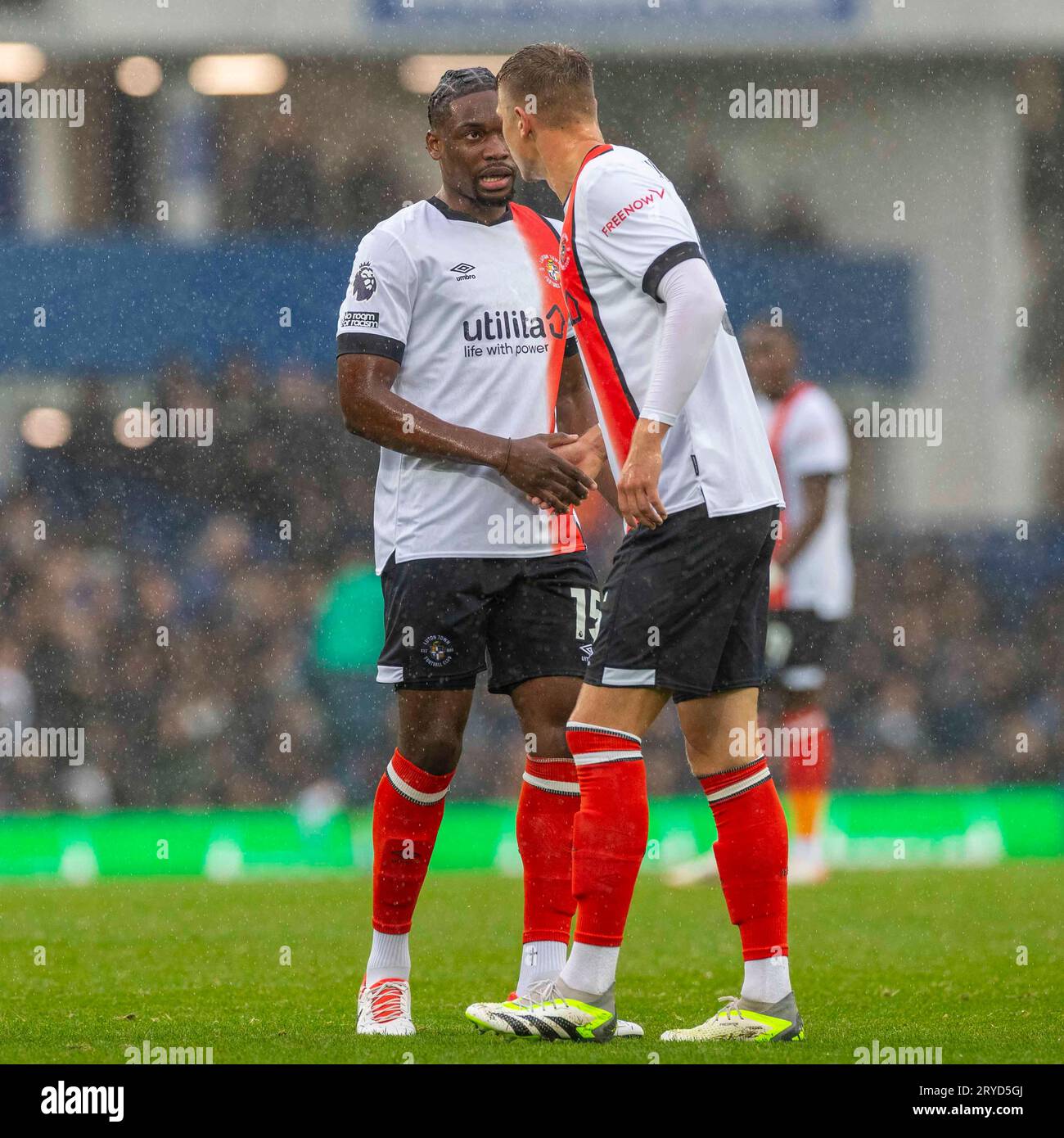 Teden Mengi #15 of Luton Town F.C talks to team-mate during the Premier ...