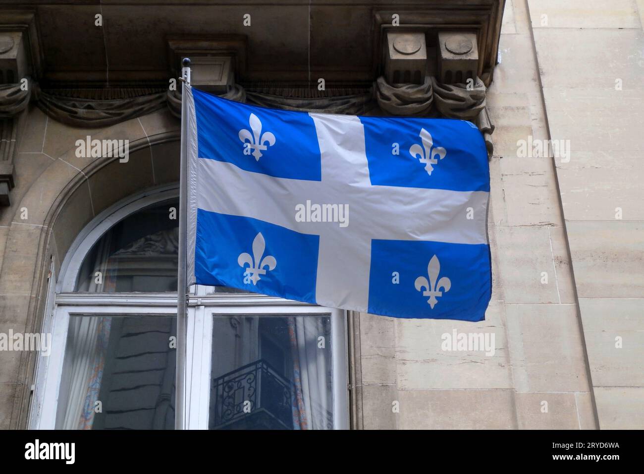 Flag of the Québec waving in front of the facade of a building Stock ...