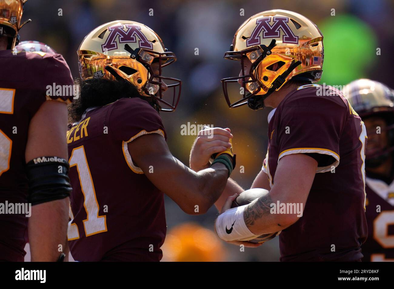 Minnesota quarterback Athan Kaliakmanis, right, celebrates with ...