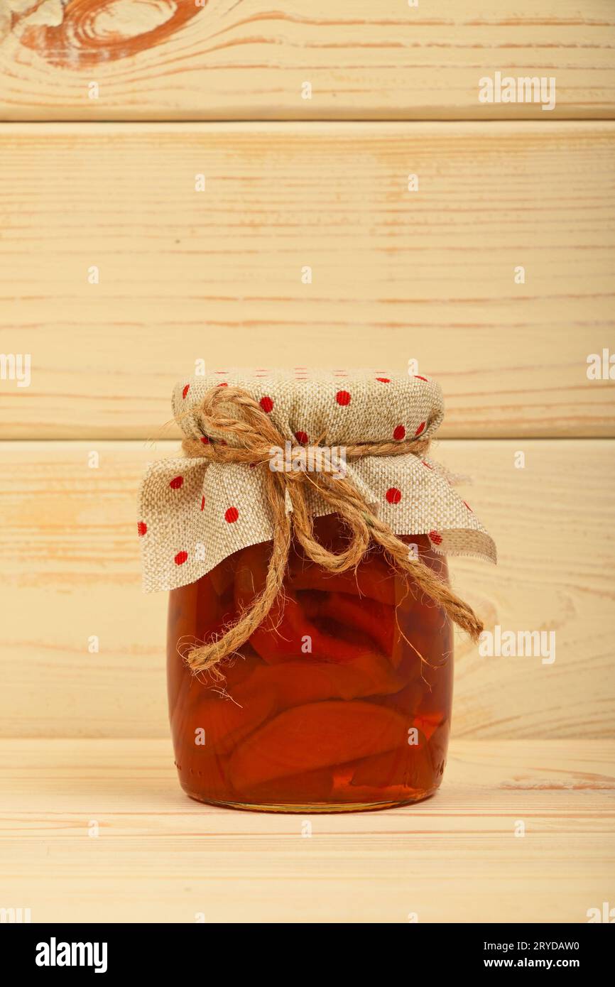 One jar of quince jam over vintage wood planks Stock Photo - Alamy