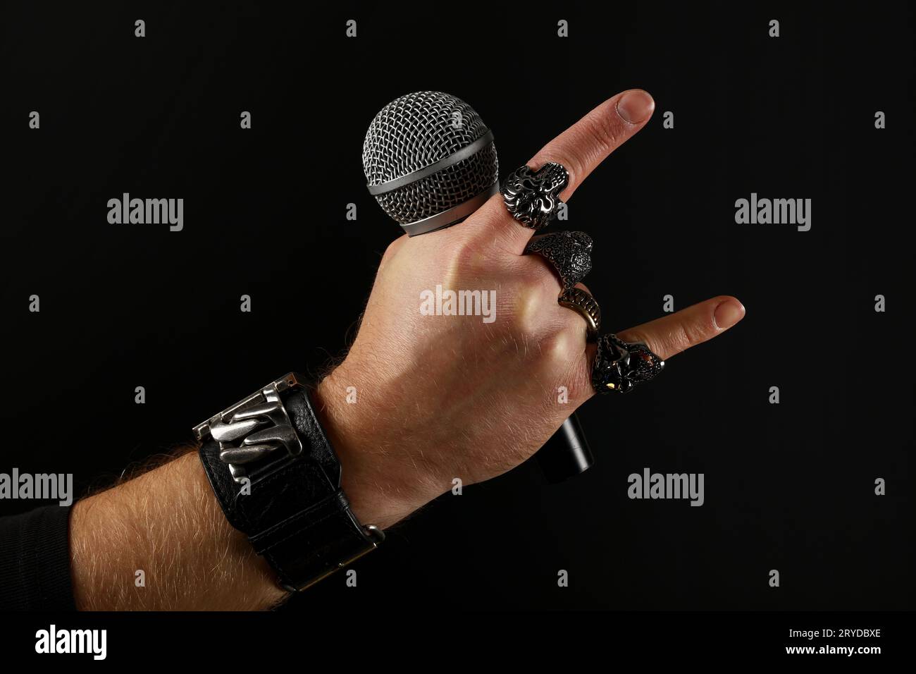 Man hand with microphone isolated on black Stock Photo - Alamy