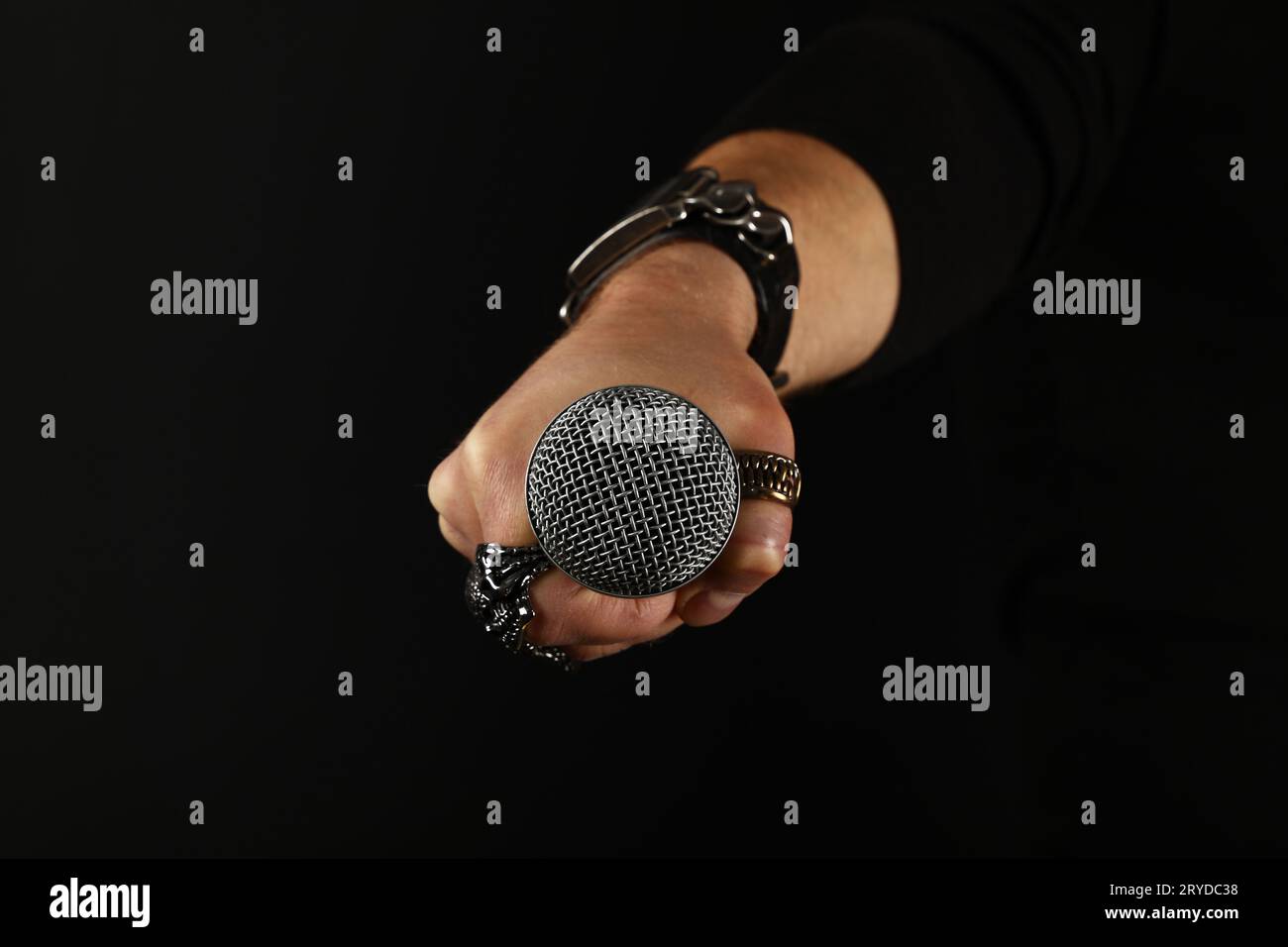 Man hand with microphone isolated on black Stock Photo - Alamy