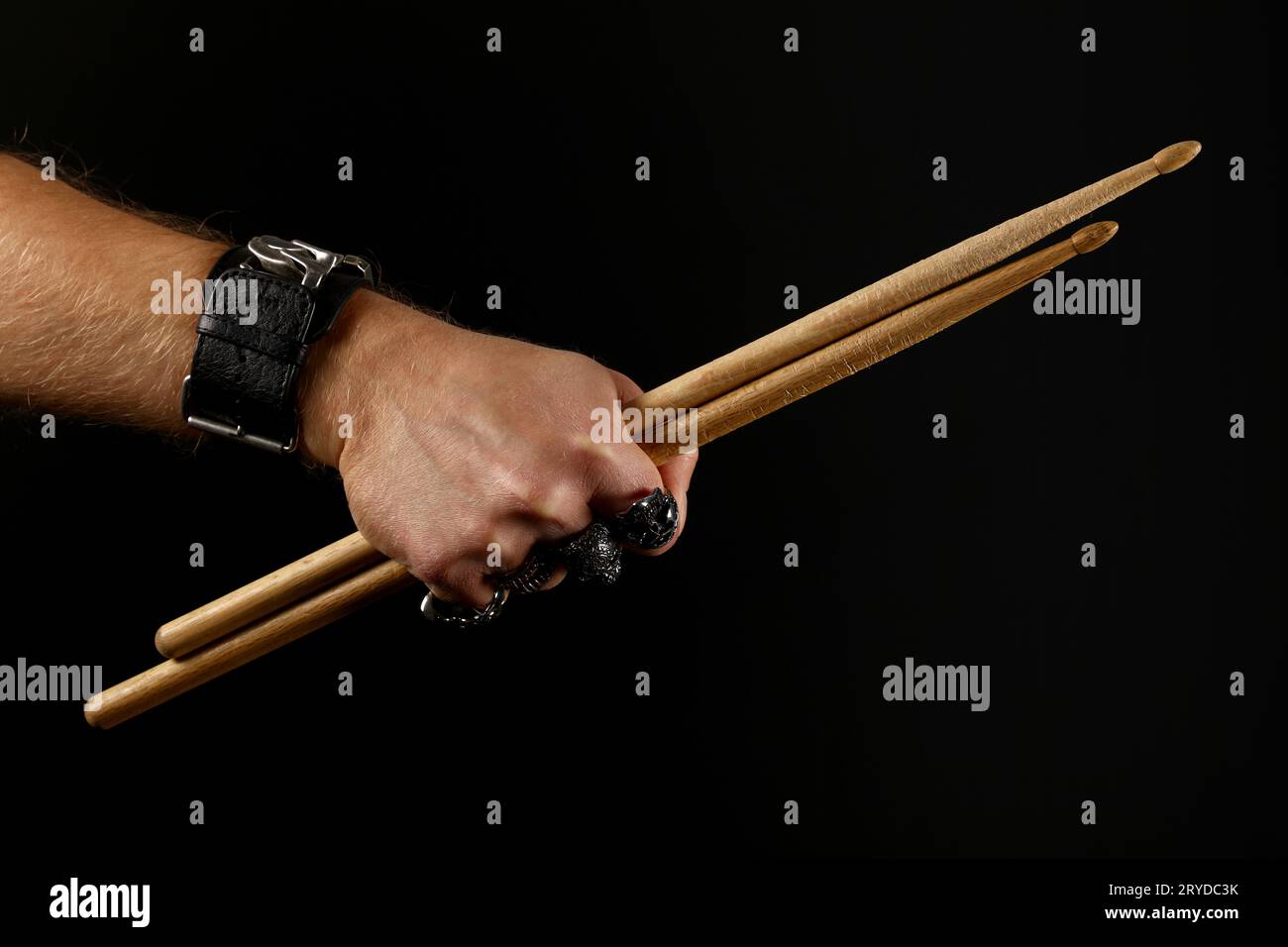 Close up man hand with drumsticks over black Stock Photo - Alamy