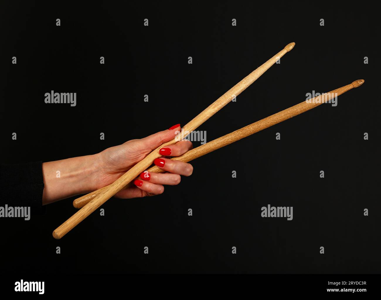Close up woman hand with drumsticks over black Stock Photo - Alamy