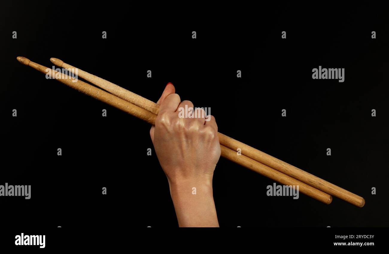Close up woman hand with drumsticks over black Stock Photo - Alamy