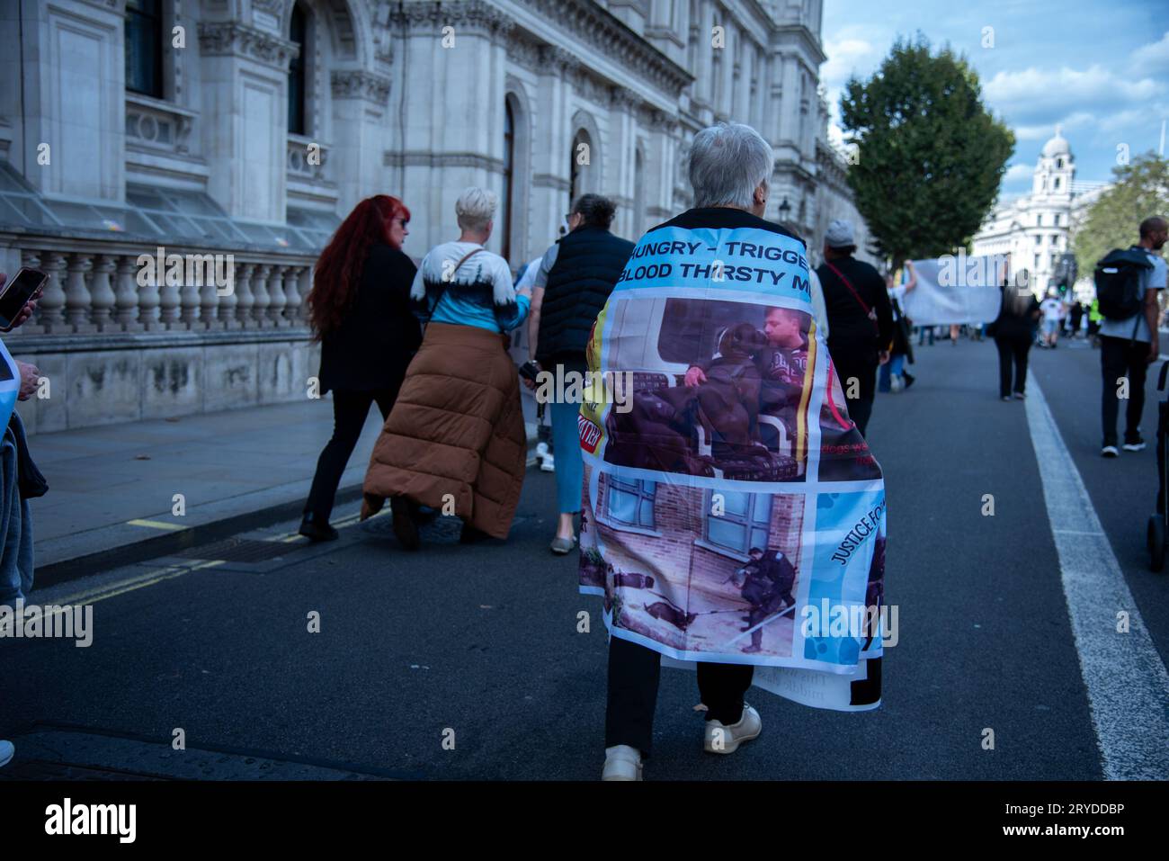 London, UK. 30th Sep, 2023. A protestor marches with a banner wrapped ...