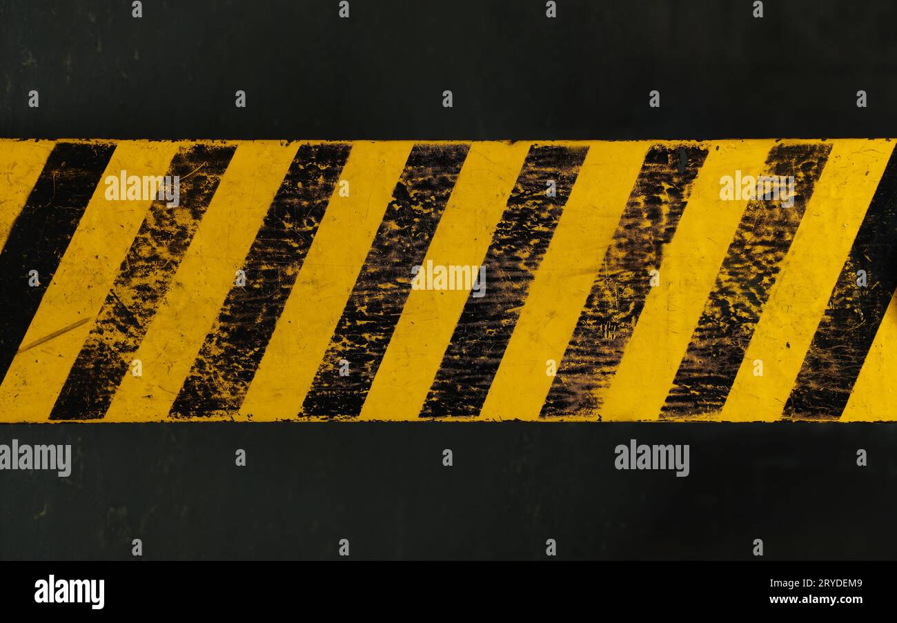 Yellow background with black grunge hazard sign Stock Photo - Alamy