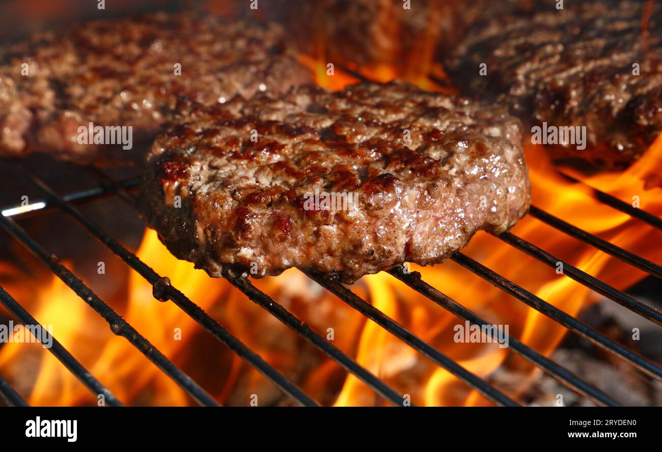 Beef burger for hamburger on barbecue flame grill Stock Photo - Alamy