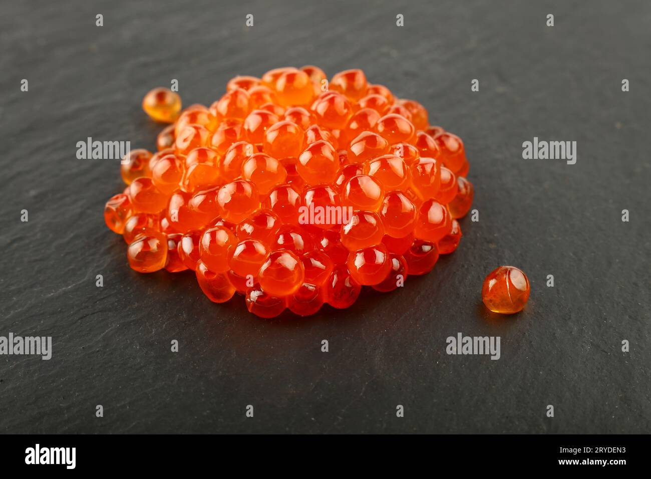 Close up heap of red salmon caviar on black Stock Photo - Alamy