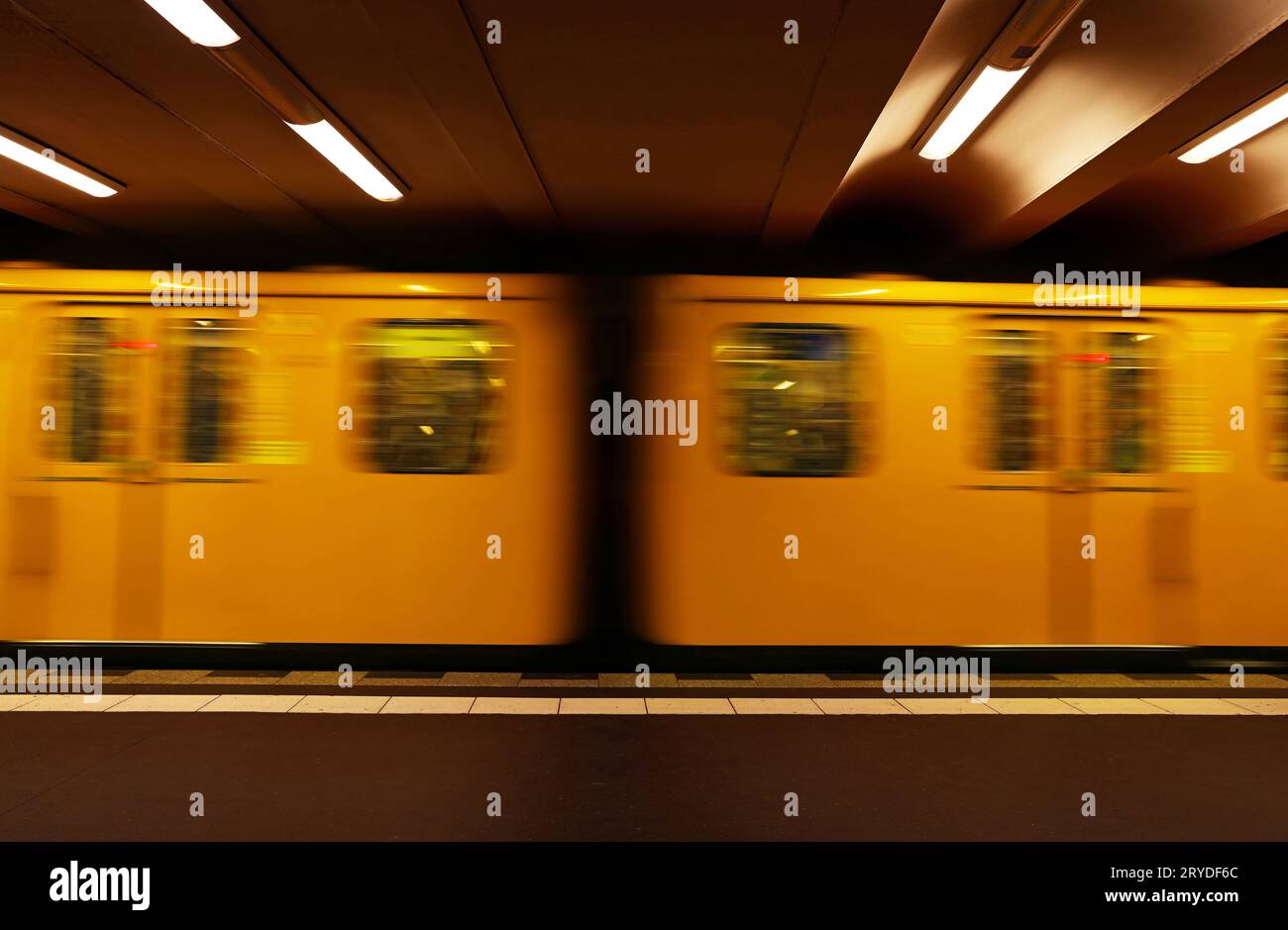 Yellow metro underground carriage of U-Bahn train in motion, side view ...