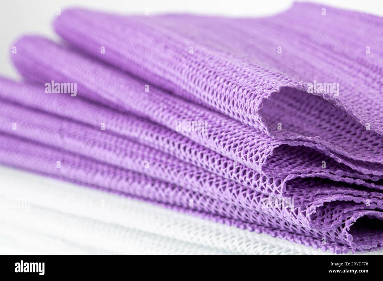 Kitchen synthetic napkin lavender color folded into folds on a white ...