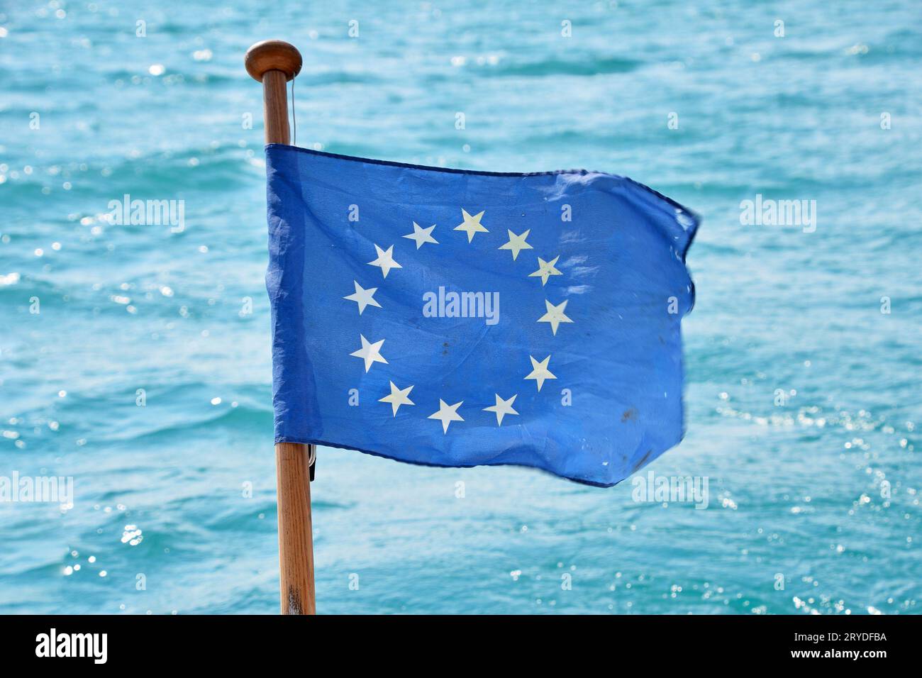 Close up flag of EU waving in wind over sea water Stock Photo - Alamy