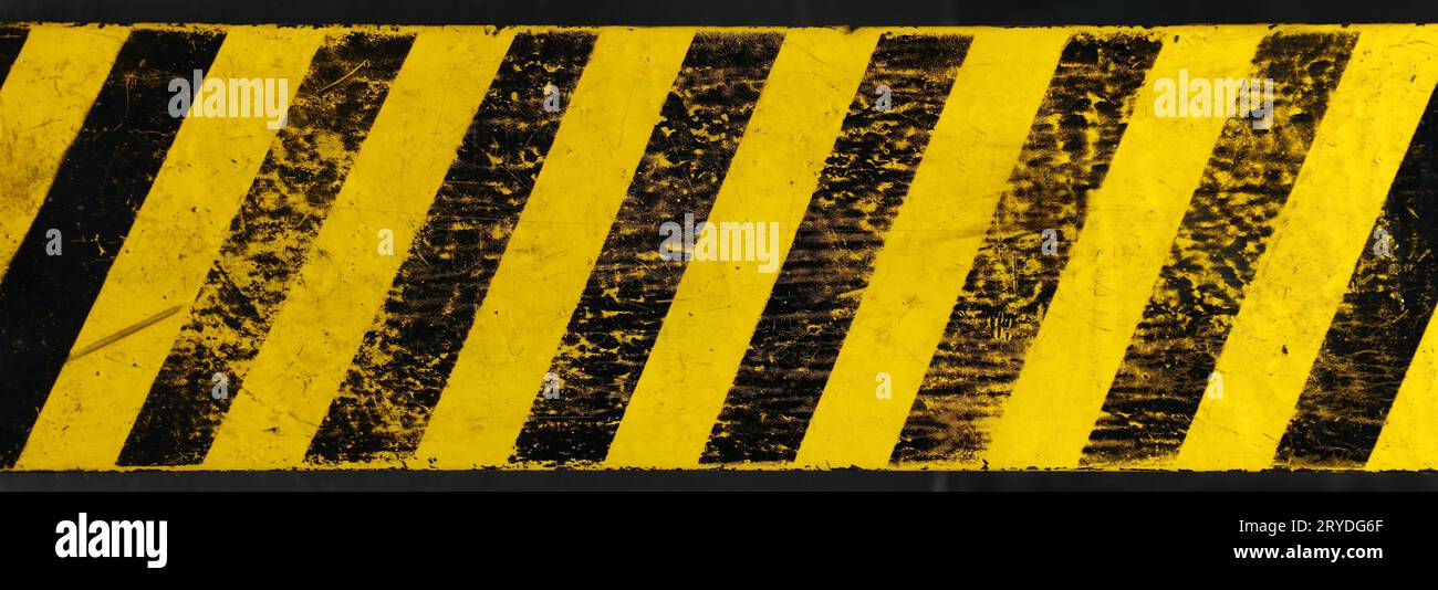 Yellow background with black grunge hazard sign Stock Photo - Alamy