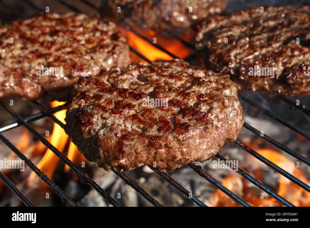 Beef burger for hamburger on barbecue flame grill Stock Photo - Alamy