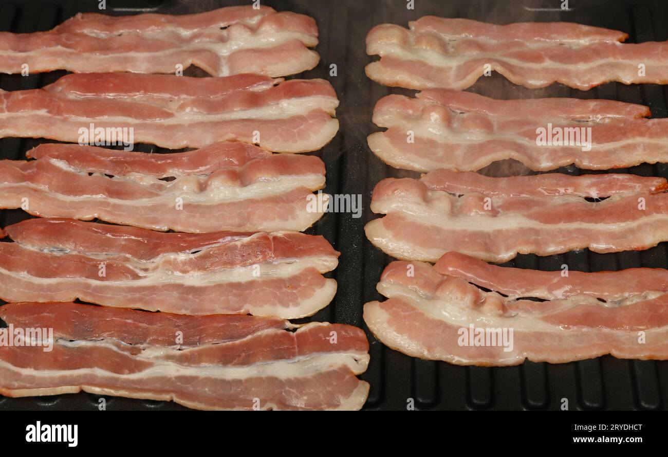Close up cooking bacon slices on electric grill Stock Photo - Alamy
