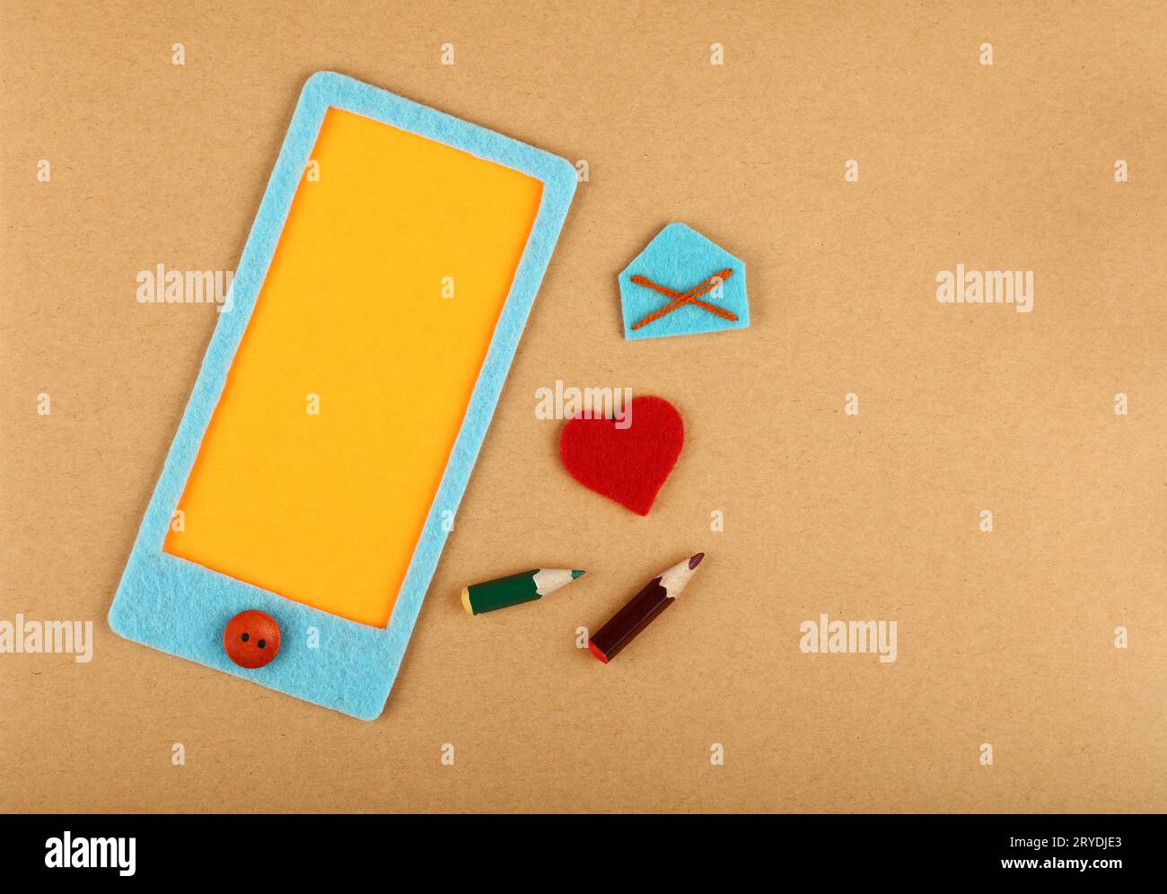 Felt craft smartphone with heart over brown paper Stock Photo - Alamy
