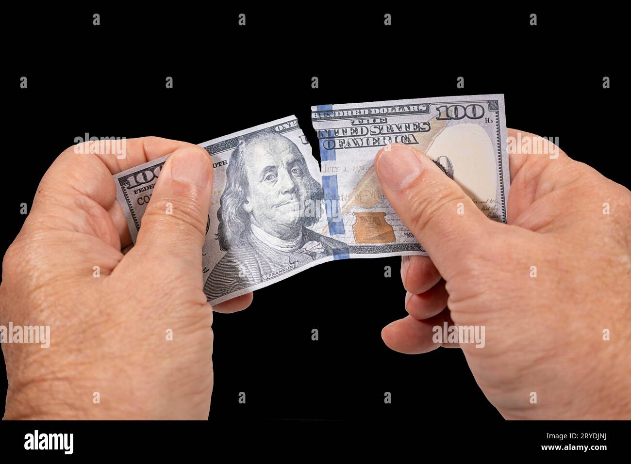 Hands tear money isolated on black background Stock Photo - Alamy
